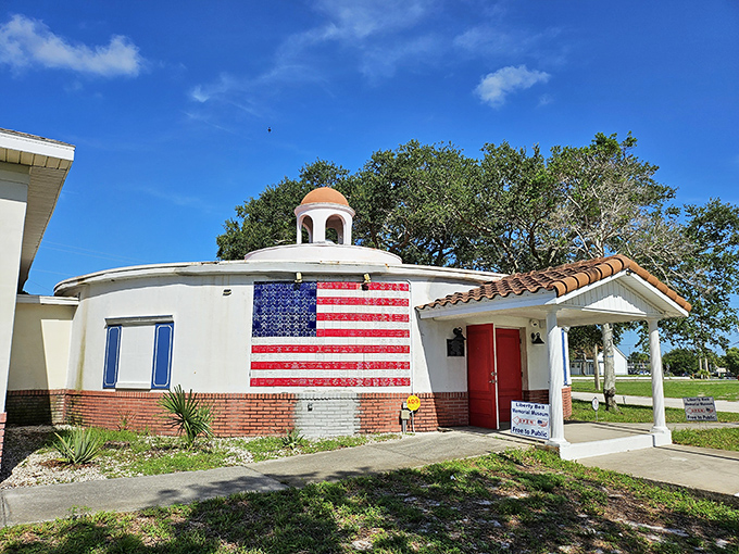 The Liberty Bell Memorial Museum stands proudly with its American flag facade, a patriotic touchstone in Melbourne's historical narrative.