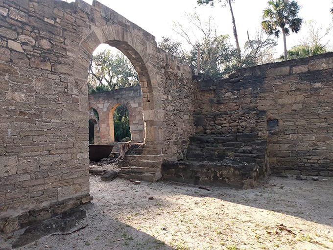 Arched doorways frame Florida wilderness, creating natural portals between industrial past and subtropical present in perfect harmony.