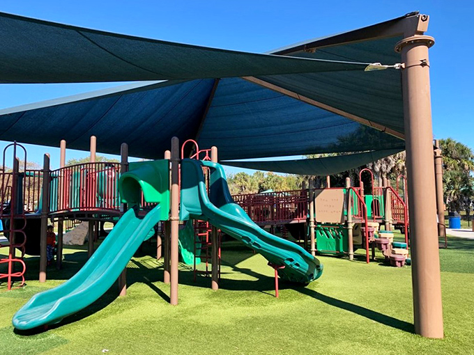 Little adventurers conquer colorful climbing structures under thoughtful shade canopies &ndash; because Florida playgrounds without shade are just cruel.