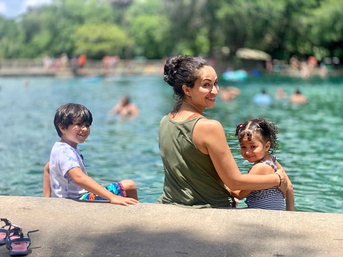 Families create lasting memories at the spring's edge, where generations have gathered to escape Florida's heat in these refreshing 72-degree waters.
