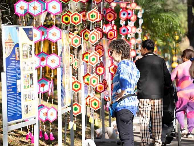 Colorful handcrafted items dangle like a rainbow suspended in mid-air, adding festive charm to the temple grounds.
