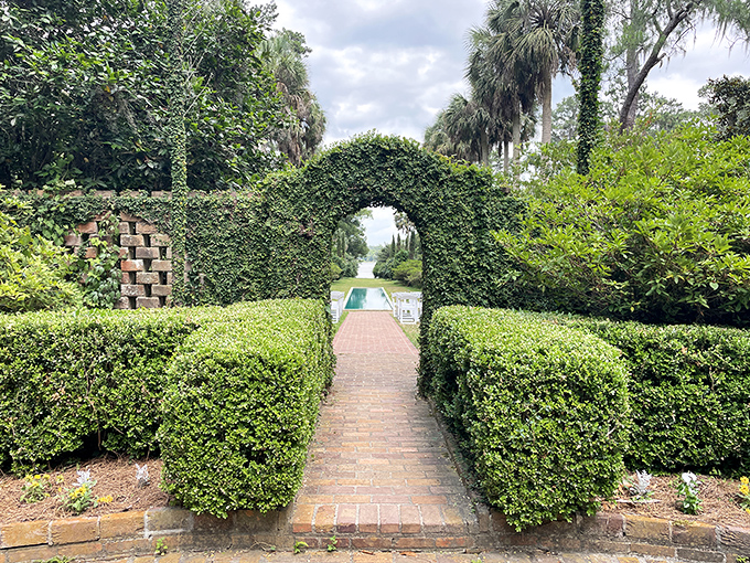 Step through this living archway and discover a secret garden room where hedges stand guard over hidden botanical treasures.