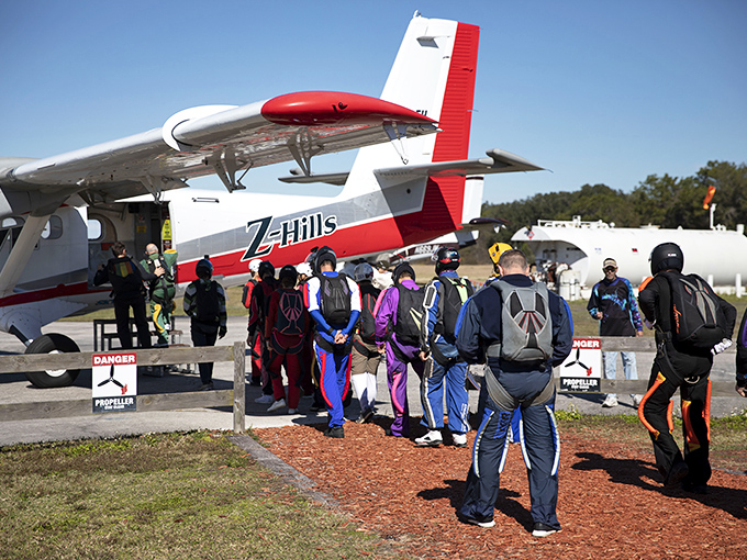 Skydivers queue up beside the Z-Hills aircraft, that mix of excitement and terror written across faces about to experience freefall.