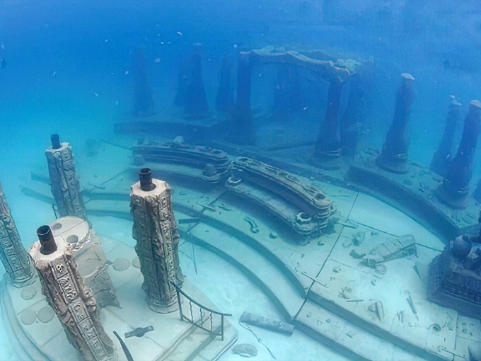The temple-like structures create an otherworldly cityscape that feels like stumbling upon an ancient civilization where fish are the new residents.