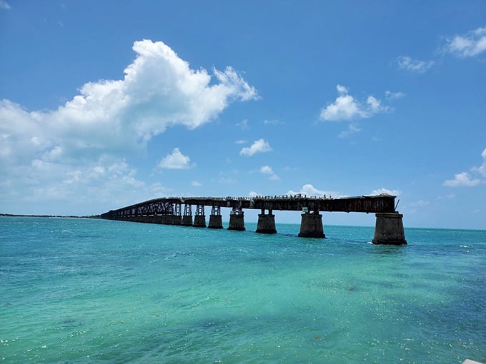 The old bridge stretches into turquoise infinity, a man-made intrusion that somehow enhances rather than detracts from nature's canvas.