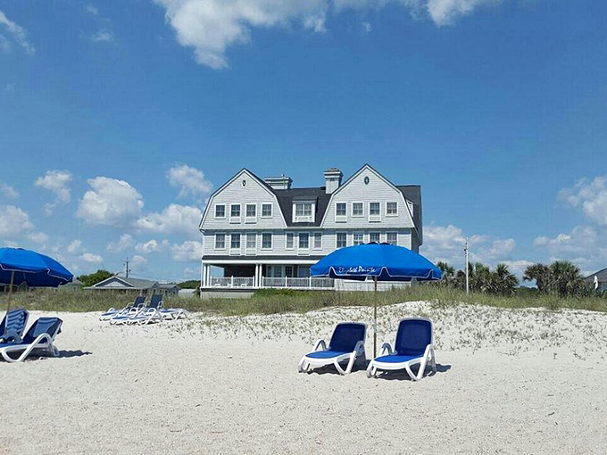Elegant Victorian architecture meets beachside relaxation at this Amelia Island gem, where rocking chairs await sunset admirers.