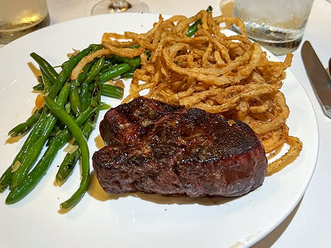 A perfectly seared steak with crispy onion strings and vibrant green beans &ndash; Bern's delivers the classic steakhouse experience with no unnecessary frills.