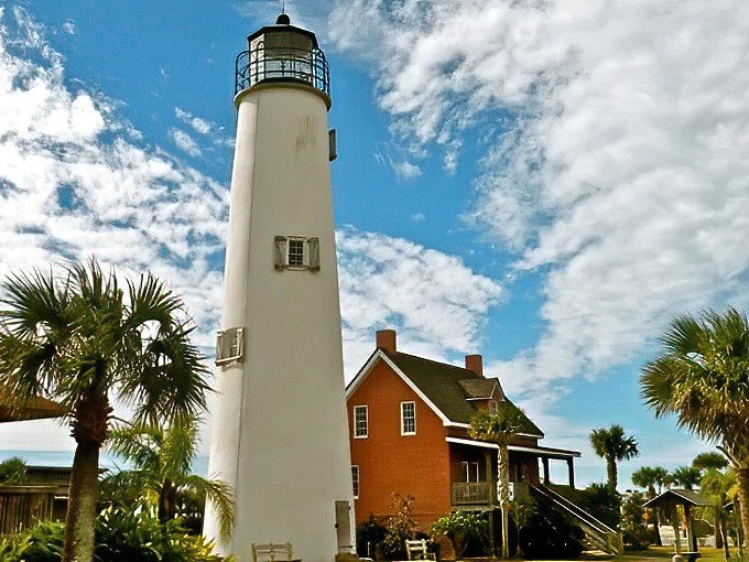 Cape St. George Light's dramatic white stand tall beside its charming keeper's house, creating a postcard-perfect scene on St. George Island.