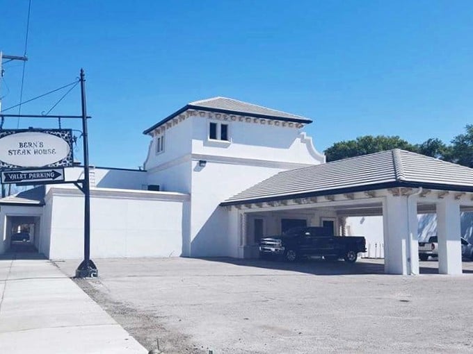 Bern's Steak House maintains its elegant white exterior, a temple to aged beef that has drawn carnivores to Tampa for generations.