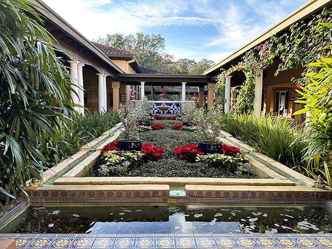 A tranquil reflecting pool bordered by vibrant flowers creates perfect symmetry at Bok Tower Gardens, a hidden oasis of calm.