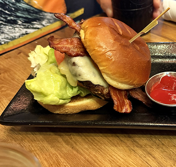 Not just any burger &ndash; The Edison's signature creation stacks premium beef, sharp cheddar, and crispy bacon into a tower of mouthwatering perfection.