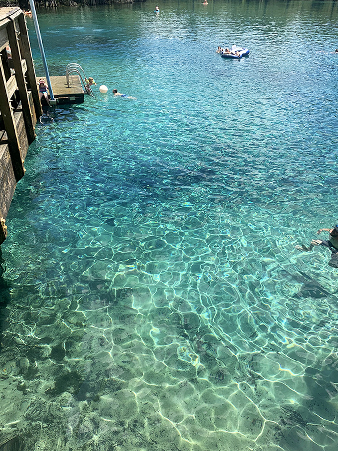 Swimmers enjoy the impossibly clear spring water, so transparent you'd swear someone installed underwater lighting when Mother Nature wasn't looking.