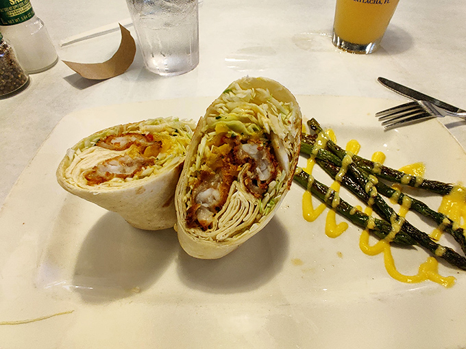 This handheld delight wraps crispy coconut shrimp in a soft tortilla with fresh veggies and a drizzle of sauce.