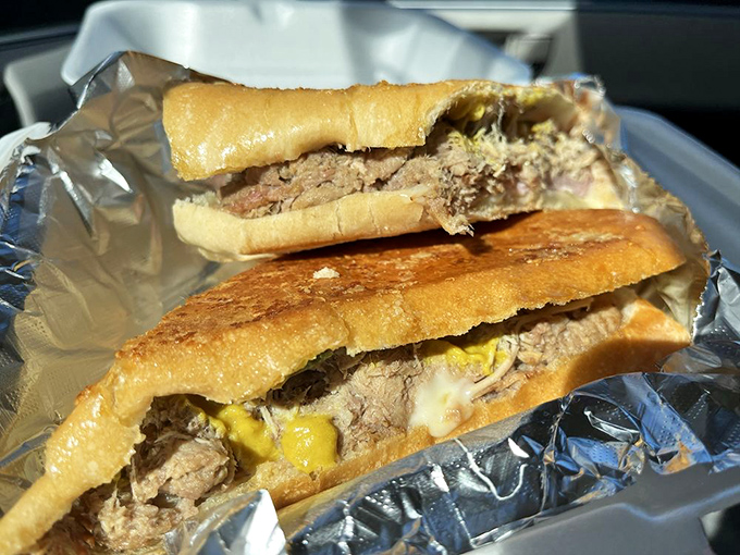 Behold sandwich perfection: layers of slow-roasted pork, ham, Swiss cheese, pickles, and mustard pressed between crispy Cuban bread.