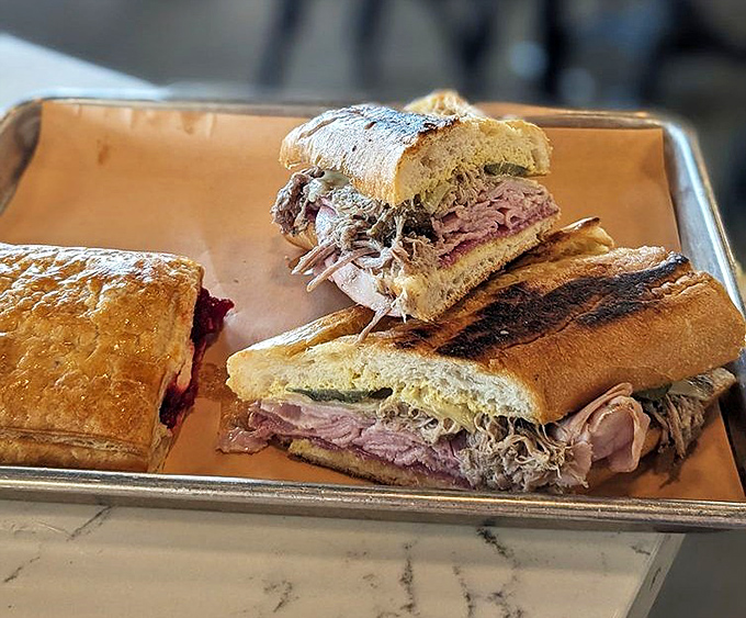 The legendary Cuban sandwich &ndash; a masterpiece of roasted pork, ham, Swiss cheese, and pickles pressed between house-baked bread until perfectly crisp.