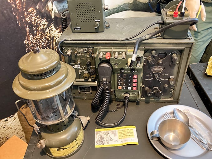 Field gear from the Vietnam era sits ready for inspection, complete with canteen, lantern, and radio equipment that makes your smartphone look positively futuristic by comparison.