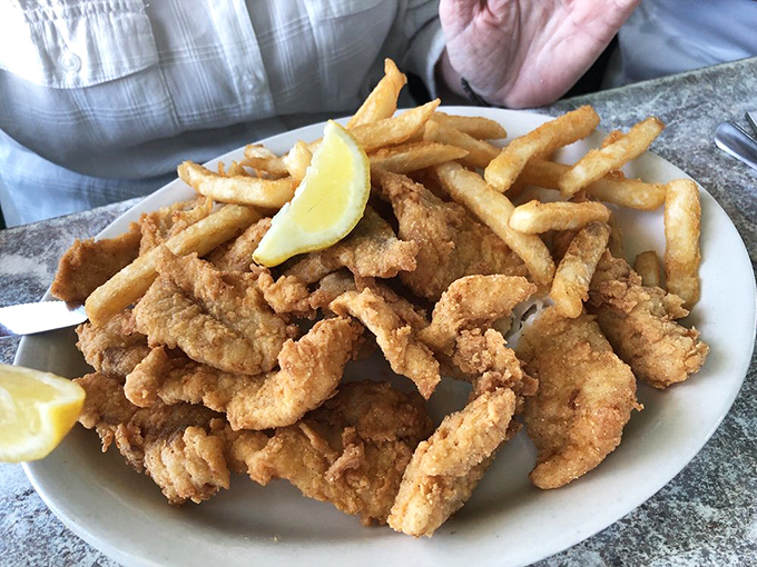 Golden-battered fish nestled against crispy fries &ndash; this isn't just fish and chips, it's Florida sunshine on a plate.