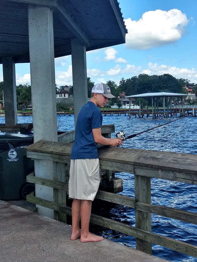 Fishing: Nothing says "authentic Florida experience" like casting a line from the public pier – this young angler's barefoot approach is pure local style.
