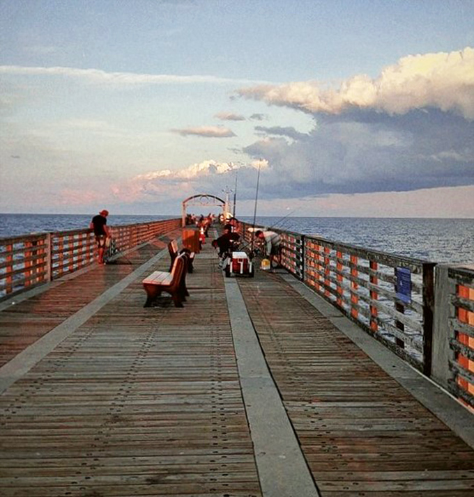 As evening approaches, fishing enthusiasts line the rails, swapping stories while waiting for the next big catch.