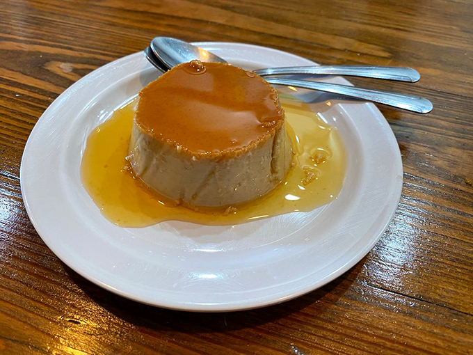 Guava flan that's sweeter than your first kiss, with caramel pooling around it like liquid sunshine on a Florida afternoon.