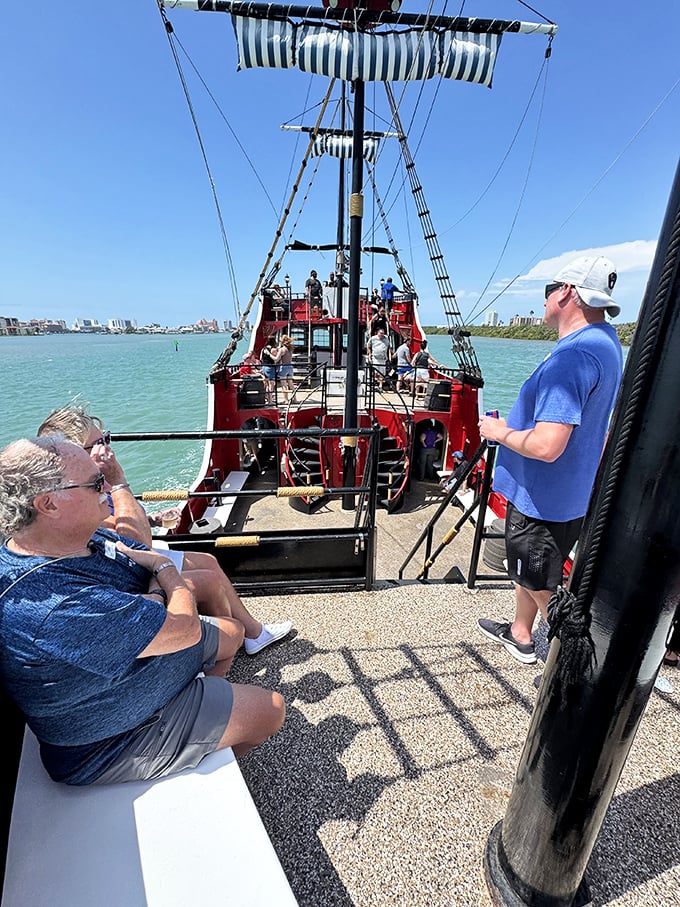 Passengers gather on deck, the anticipation of adventure written across their faces as clearly as X marks the spot.