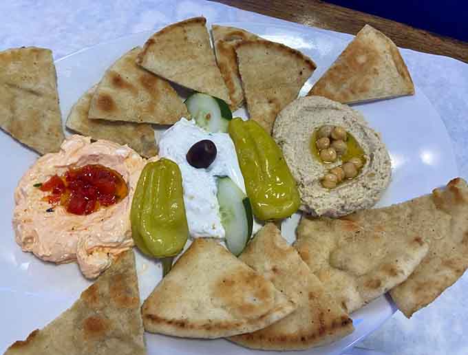 Warm pita, creamy hummus, tangy peppers, and feta that knows exactly what it's doing&mdash;this is how you start a meal right.