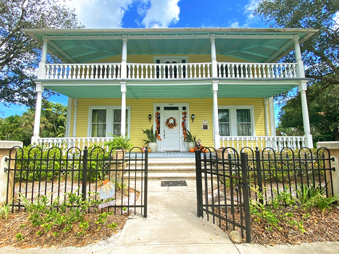 Sunshine yellow with pristine white trim, the Rossetter House stands as a Victorian time capsule behind its protective wrought iron fence.