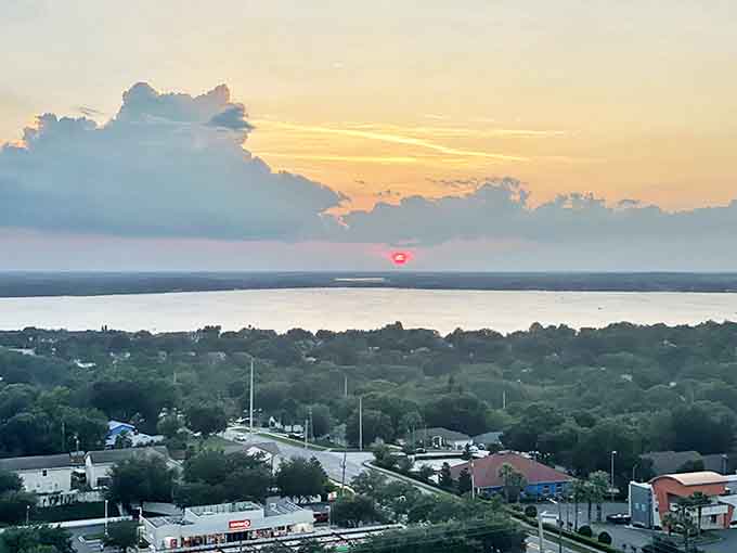 Lakeside Sunset View: As the sun dips below the horizon, the view from the tower transforms into a painter's palette of oranges and pinks reflected in the scattered lakes below.
