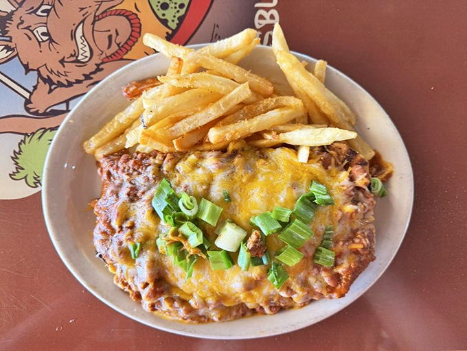 This isn't just chili – it's a volcanic eruption of beefy goodness, melted cheese, and green onions that requires both a fork and a strategy.