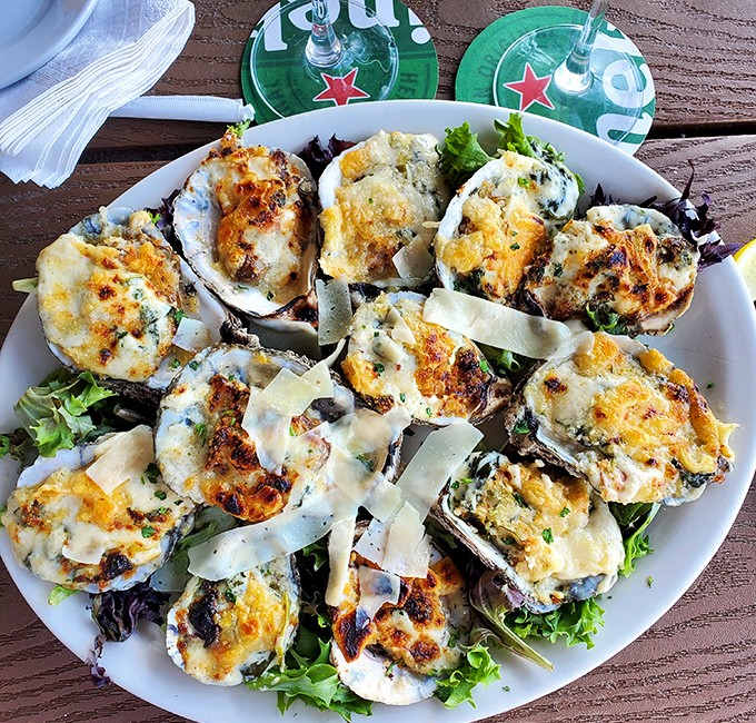 These Oysters Rockefeller aren't just appetizers &ndash; they're little boats of bliss sailing on a sea of spinach, bacon, and creamy sauce.