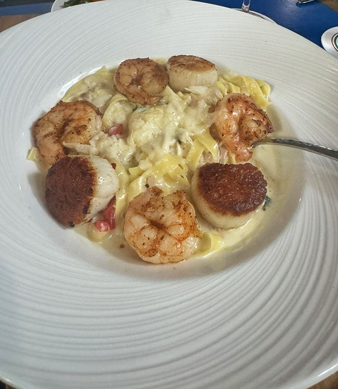 Plump scallops and shrimp play hide-and-seek among tender pasta ribbons, all swimming in a sauce worth bottling.