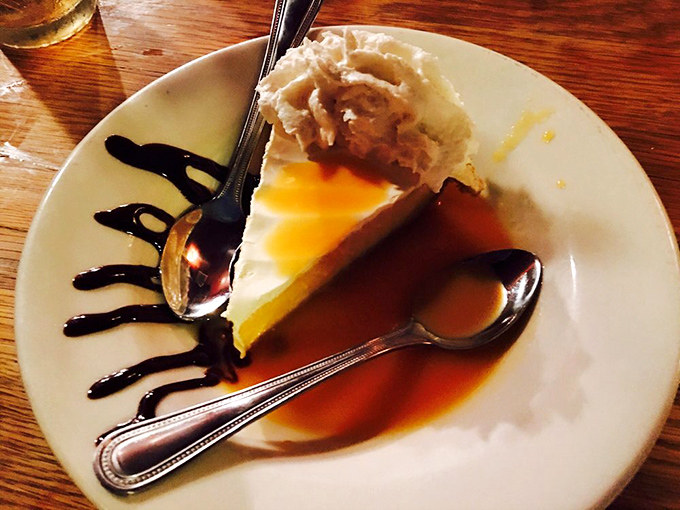 The legendary sour orange pie arrives with a perfect balance of sweet and tart, topped with a cloud of whipped cream slowly melting into the warm slice.