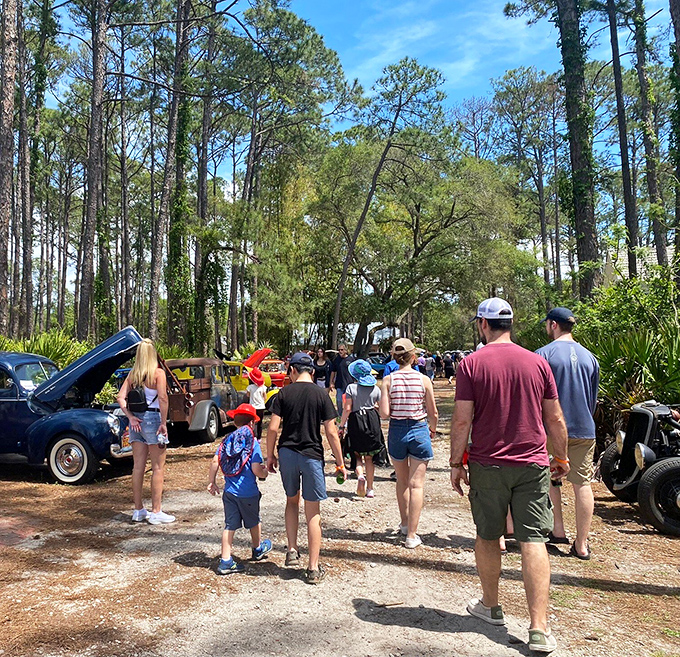 Visitors stroll through living history at Heritage Village, where Florida's past comes alive under the dappled shade of towering pines.