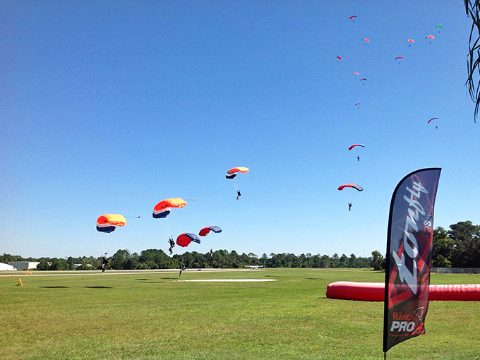 Multiple parachutes dotting the sky like colorful jellyfish, except these ones won't sting you and actually want you to survive.