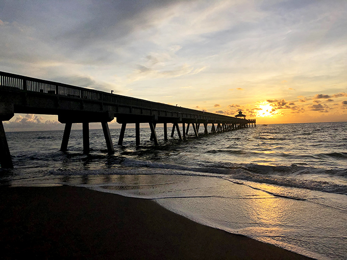 Sunset transforms the pier into a silhouette artist's dream, painting the sky in hues that would make even Bob Ross exclaim, "Happy little clouds!"