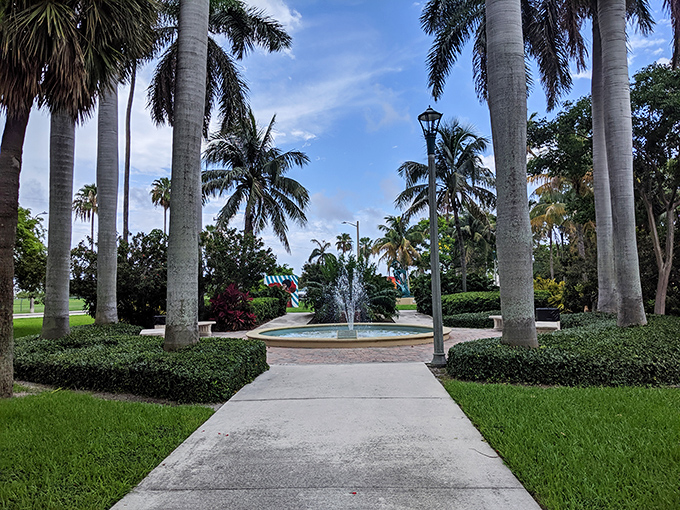 The elegant water fountain stands surrounded by royal palms, creating a classic Florida landscape that's perfect for photos.