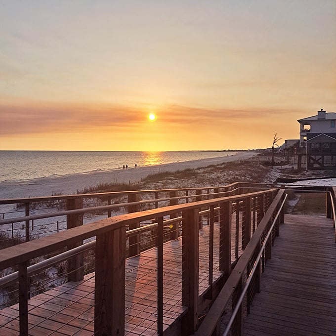 The wooden boardwalk invites visitors to venture closer to the water's edge, each plank telling stories of past sunsets.