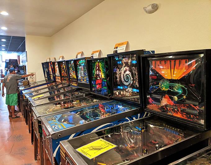 A player loses himself in concentration, the familiar click of buttons and joystick movements creating a rhythm as old as arcades themselves.