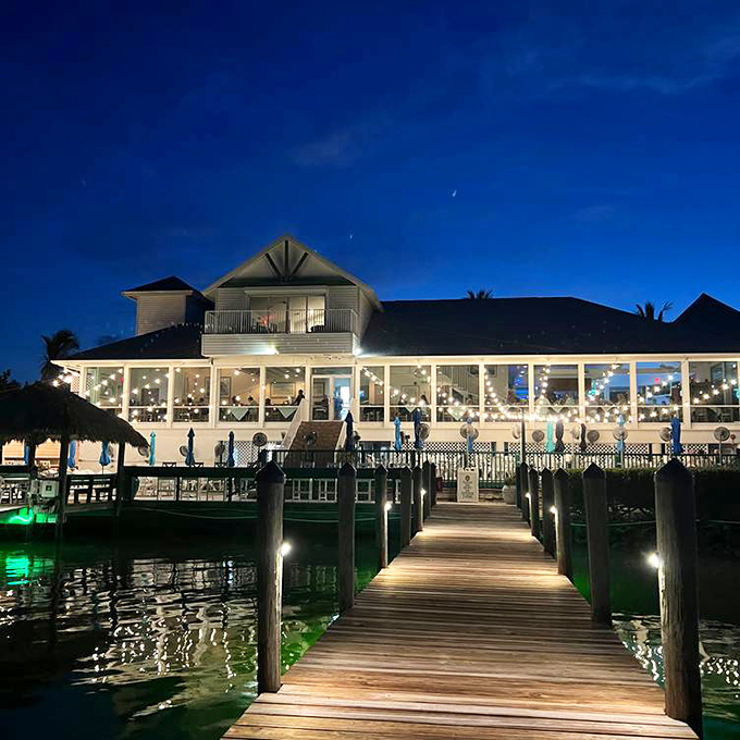 As evening falls, this waterfront Captiva Island restaurant transforms into a glowing beacon for hungry travelers seeking fresh seafood and island vibes.