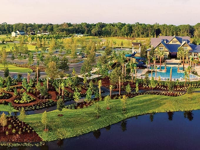 Pristine landscaping around community pools demonstrates how thoughtful design creates resort living right in your own neighborhood every day.