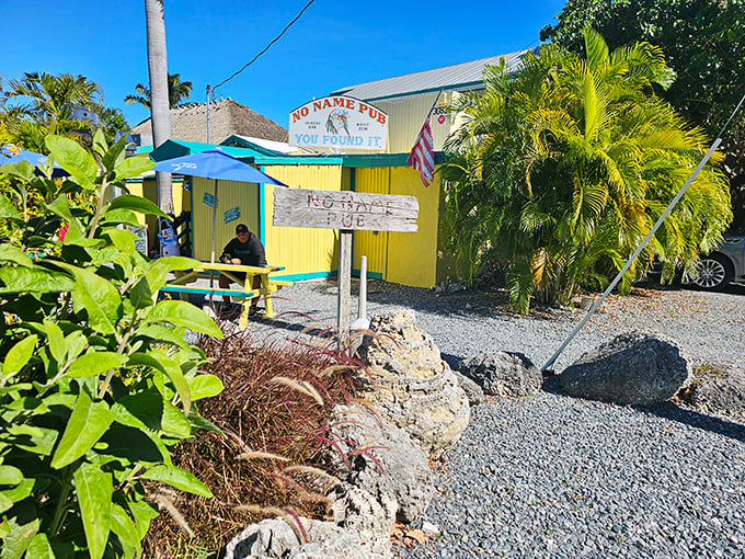 No Name Pub's casual outdoor seating offers a perfect spot to enjoy their famous pizza before heading inside to see the dollar bill-covered walls.