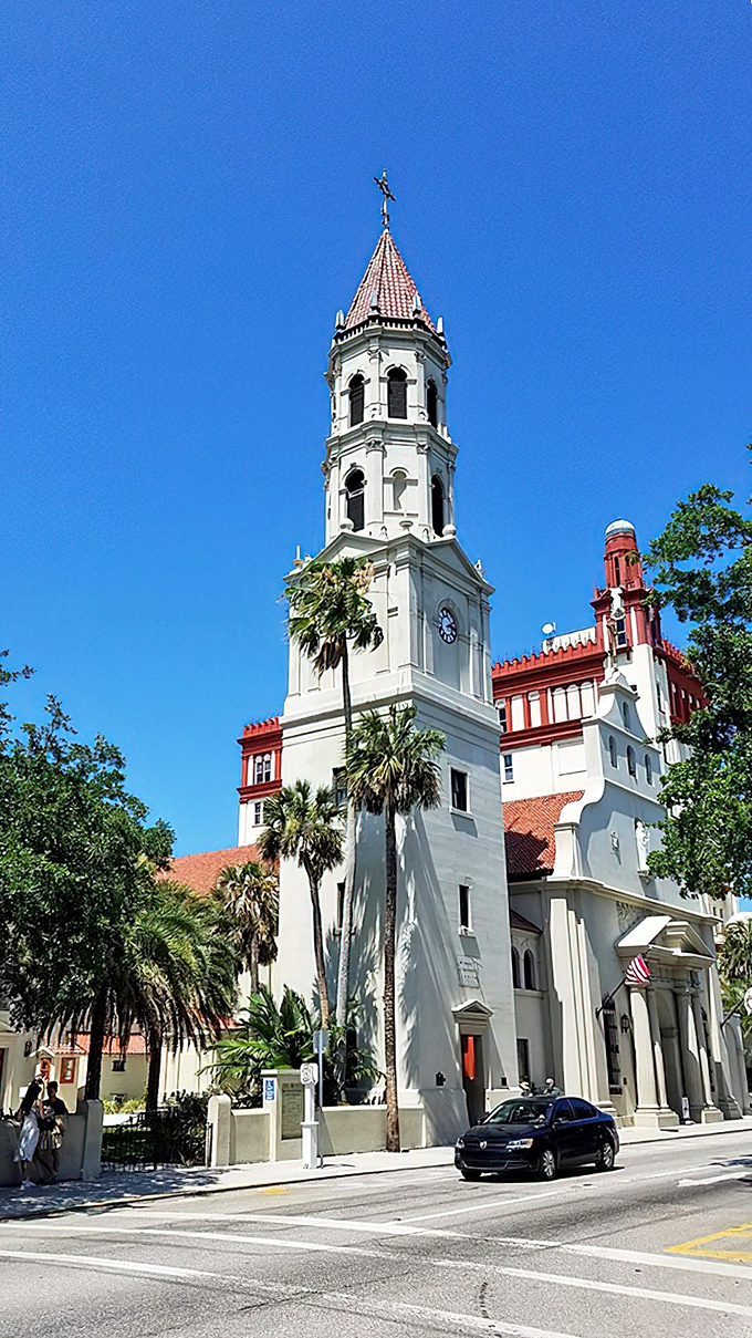 Heavenly spire! This majestic tower reaches skyward like a Spanish prayer, palm trees genuflecting beneath.