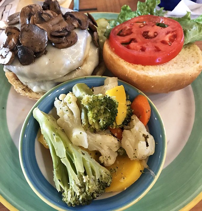 A burger crowned with mushrooms, fresh vegetables on the side&mdash;proof that sometimes the simplest pleasures are the most satisfying. No filter needed.