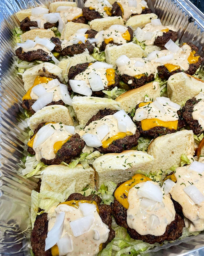 A battalion of sliders ready for deployment, each one a perfect two-bite ambassador of flavor that makes sharing optional, not mandatory.