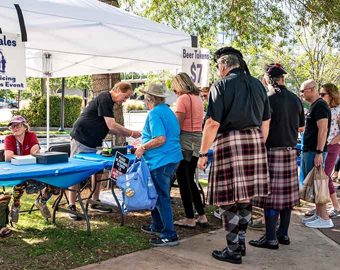 Festival booths offer everything from clan information to beer tokens, because nothing says "cultural education" quite like a well-organized vendor area with adult beverages available.