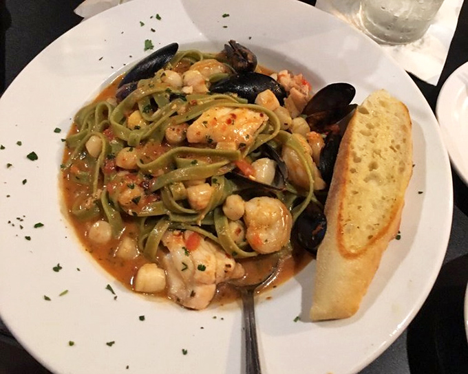Frutti di mare loaded with mussels and seafood over green linguine, because sometimes you need the ocean on a plate.