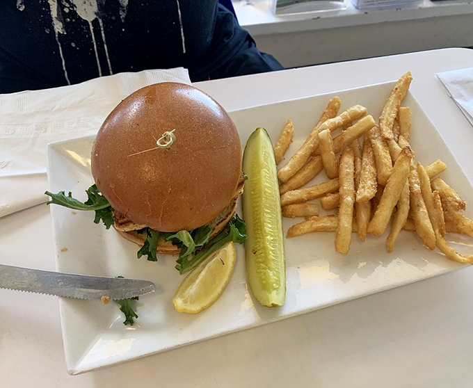 This isn't just a sandwich; it's Florida on a plate&mdash;a perfectly grilled burger with the requisite pickle spear standing at attention like a culinary salute.