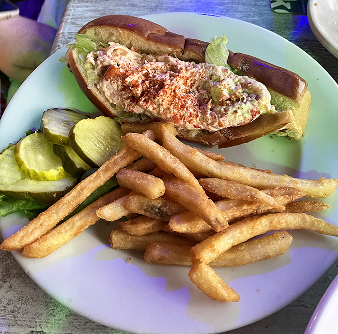 Tender chunks of sweet lobster meat nestled in a perfectly toasted roll – simple perfection with ocean views.