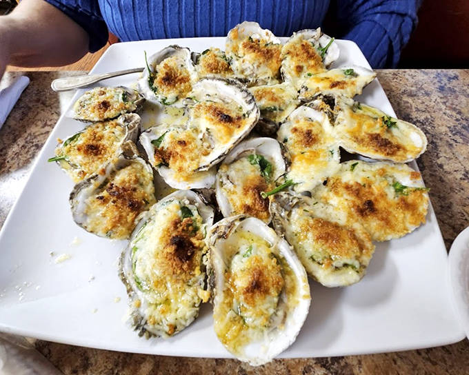 Oysters Rockefeller &ndash; where briny bivalves meet creamy, cheesy topping in a romance that would make even the most dedicated raw oyster purist consider switching teams.