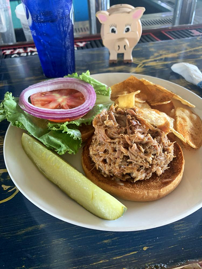 This pulled pork sandwich isn't just food &ndash; it's edible evidence of barbecue mastery, tender strands of smoky goodness piled high with fresh fixings.